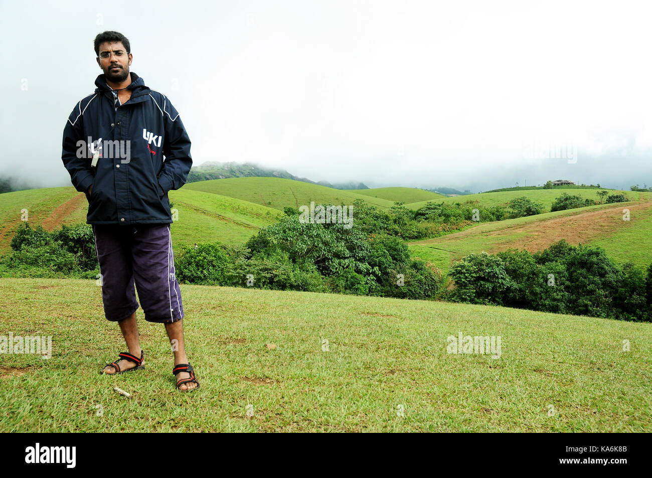 Beautiful young man smiling and posing with mountains landscape Stock ...