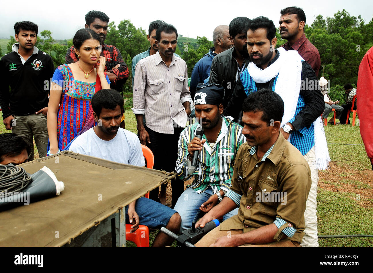 Film Crew On Location Morning Shoot watching a performance reply at ...