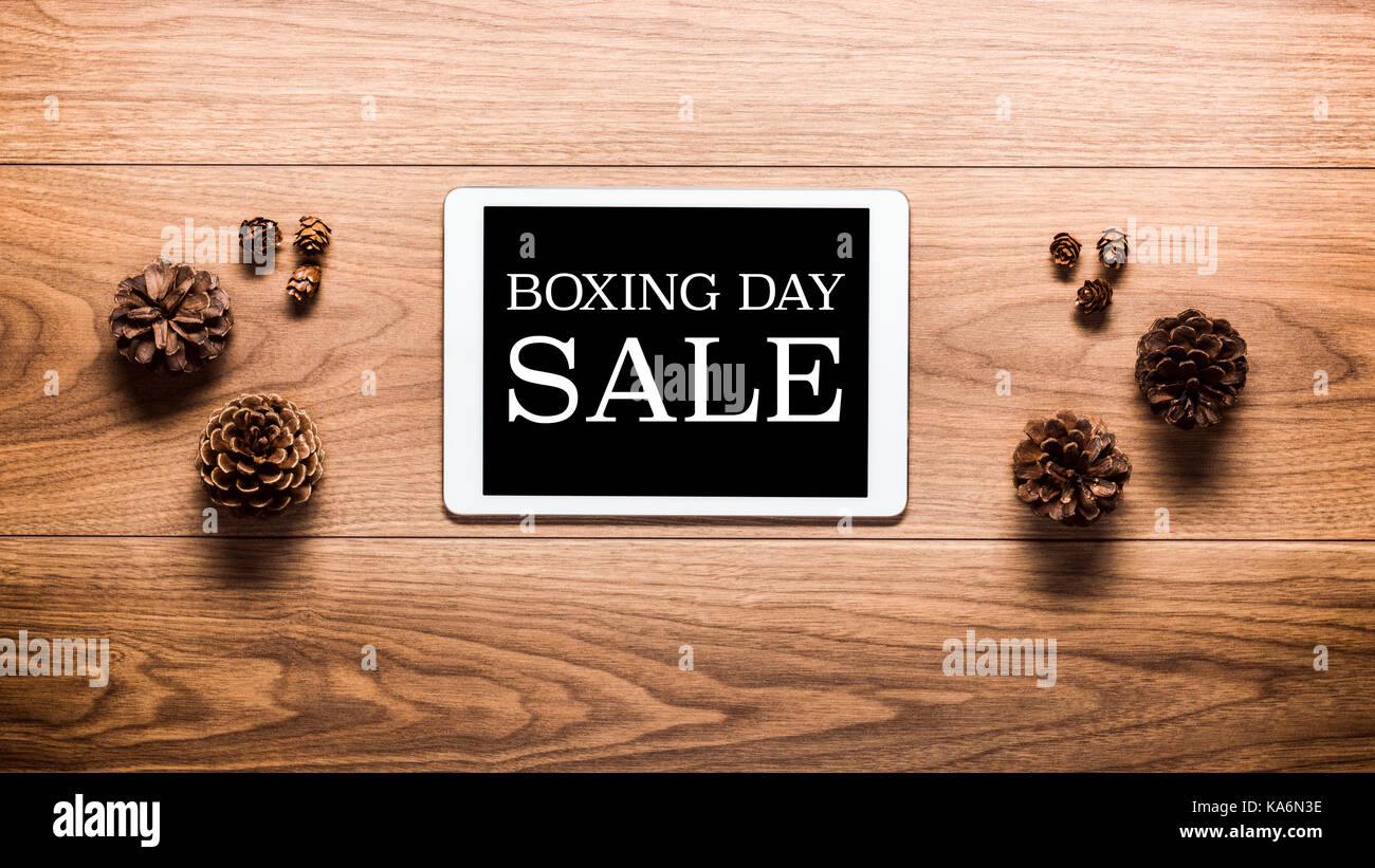 Magical Boxing Day Sale theme background, pine cones and digital tablet ...
