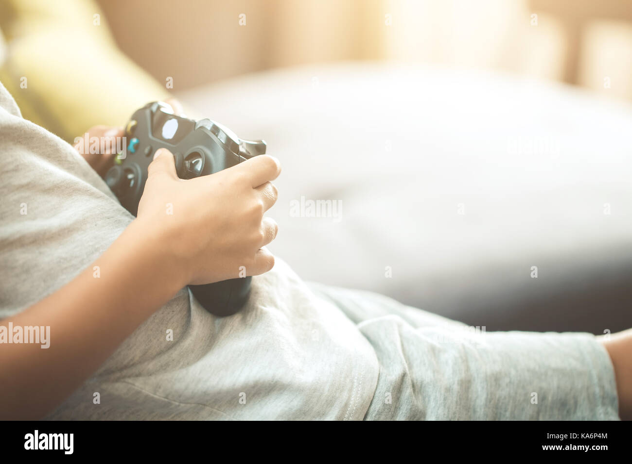 Close up of child hands holding a joystick controller while playing a ...