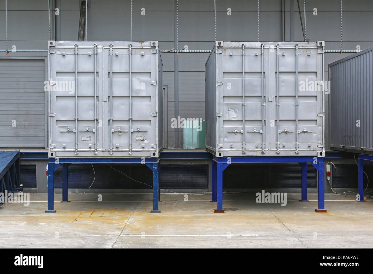 Two Silver Shipping Containers in Front of Warehouse Stock Photo - Alamy