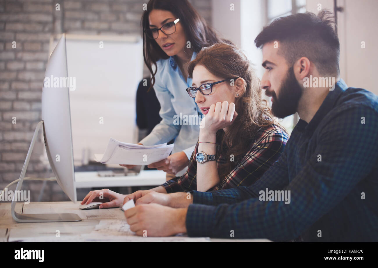 Creative coworkers working in office Stock Photo - Alamy