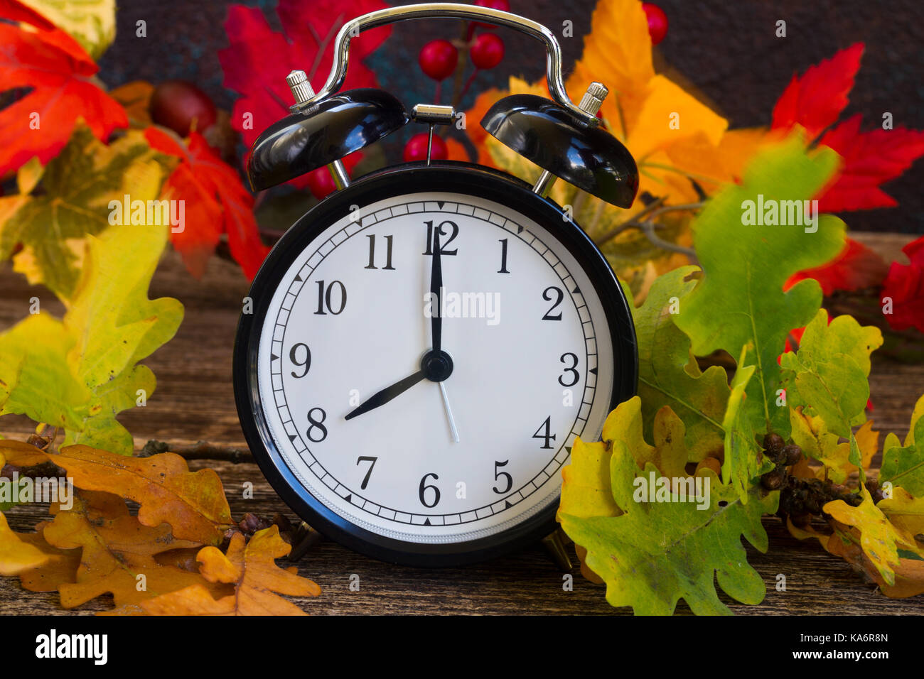 Autumn time - fall leaves with clock Stock Photo - Alamy
