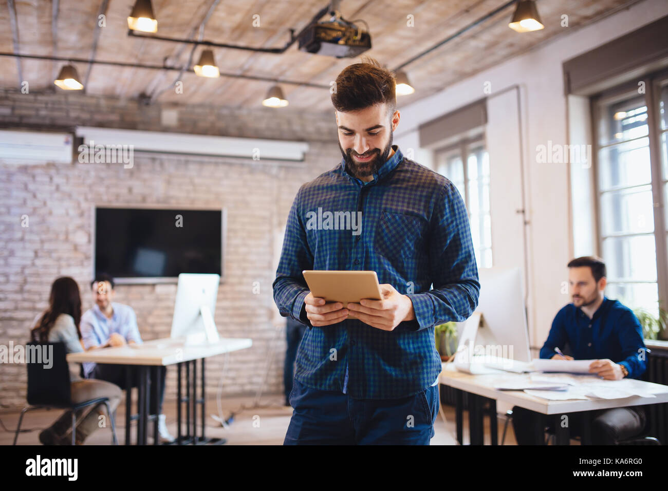 Portrait of handsome male company trainee in office Stock Photo - Alamy
