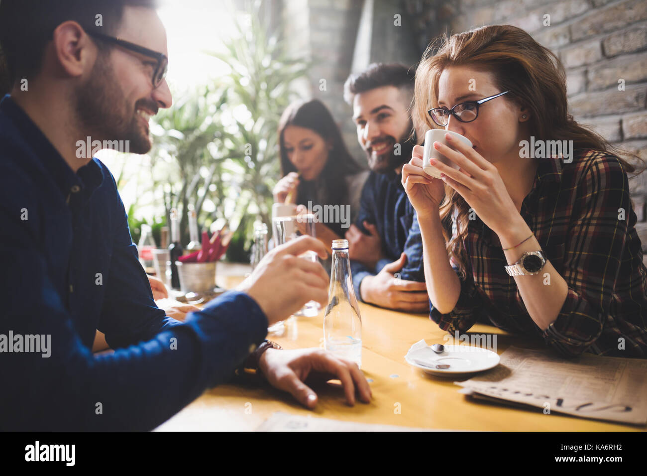 Colleagues from work socializing in restaurant and eating togeth Stock ...