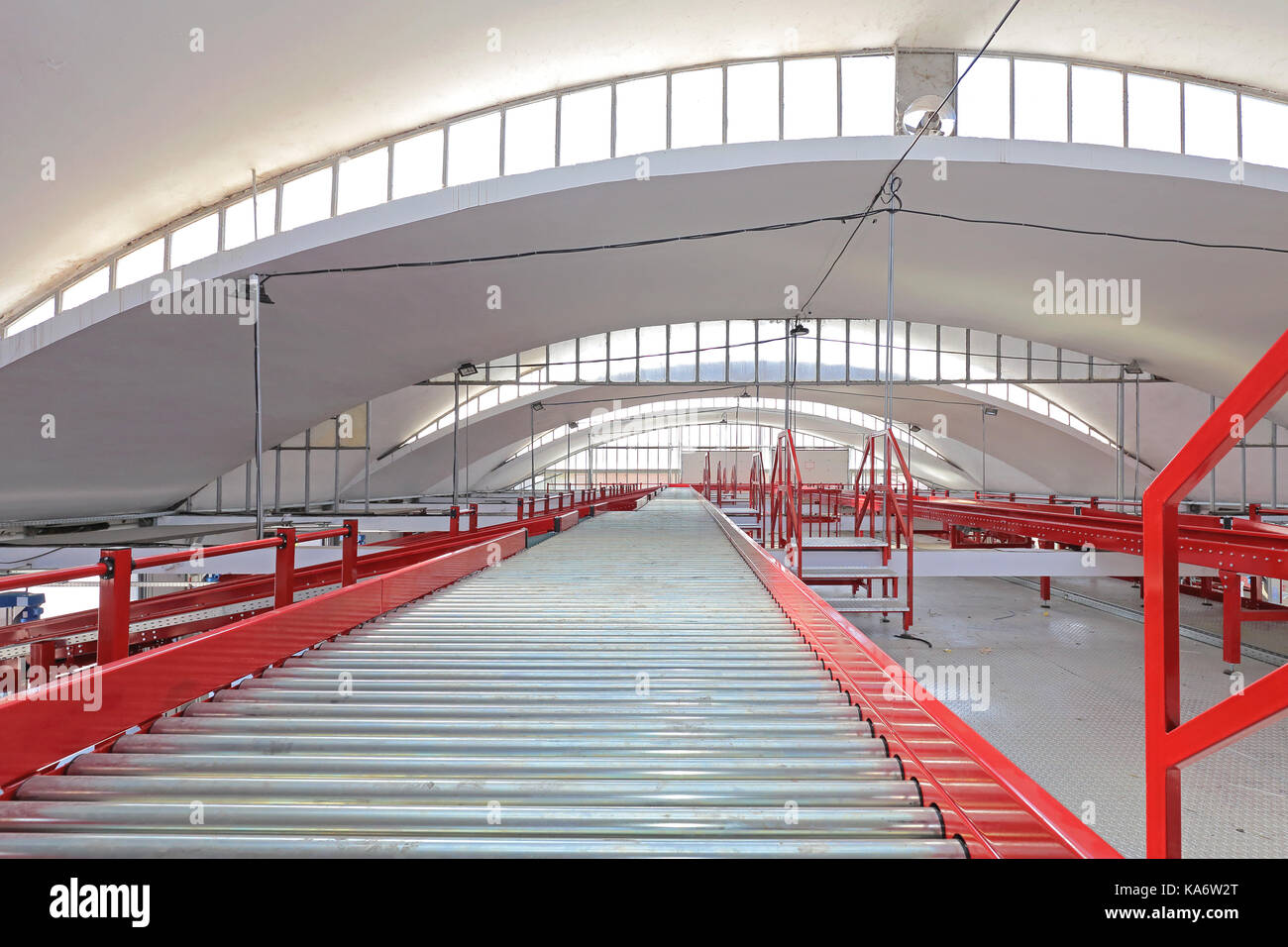 Conveyor Rollers in Shipping Distribution Warehouse Stock Photo - Alamy