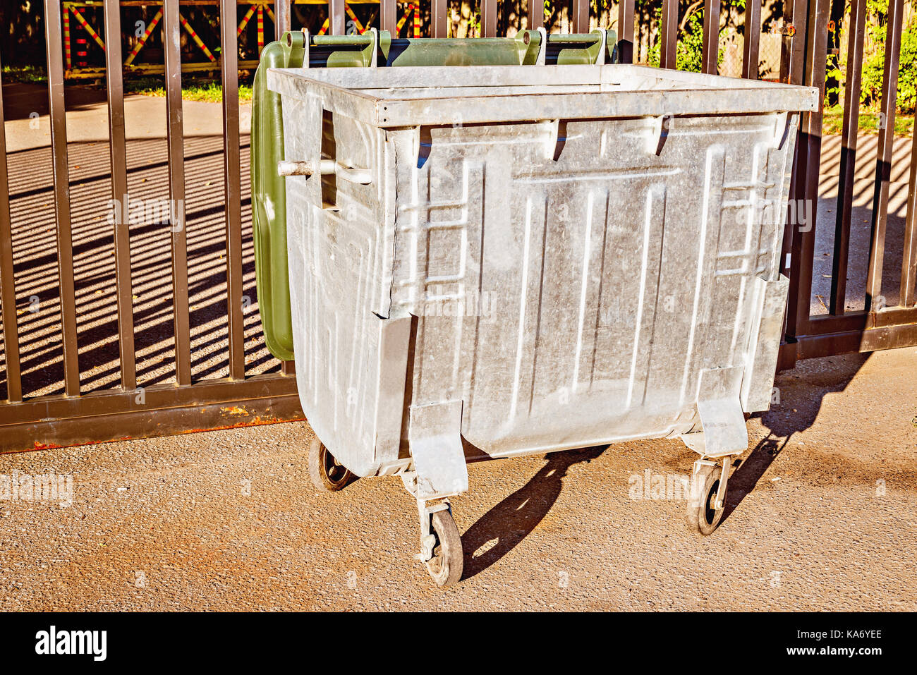 Metal container for the waste collection by the fence Stock Photo - Alamy