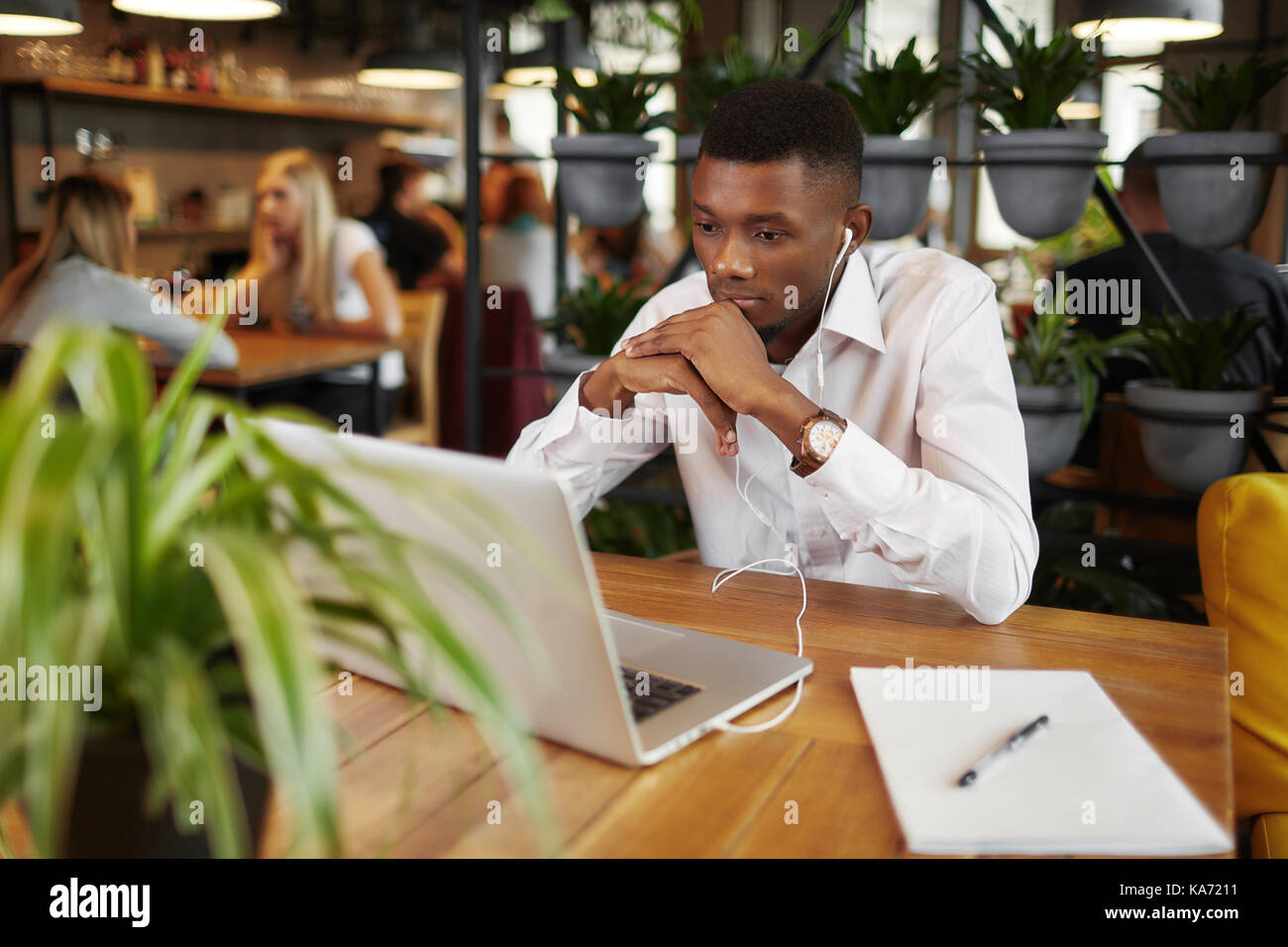 African freelancer working at restaurant with laptop Stock Photo - Alamy