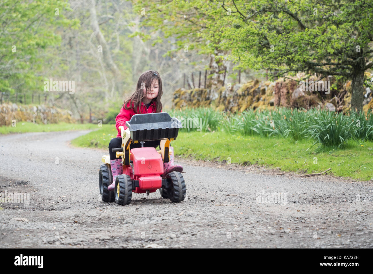 Tractor driving on the lane Stock Photo - Alamy