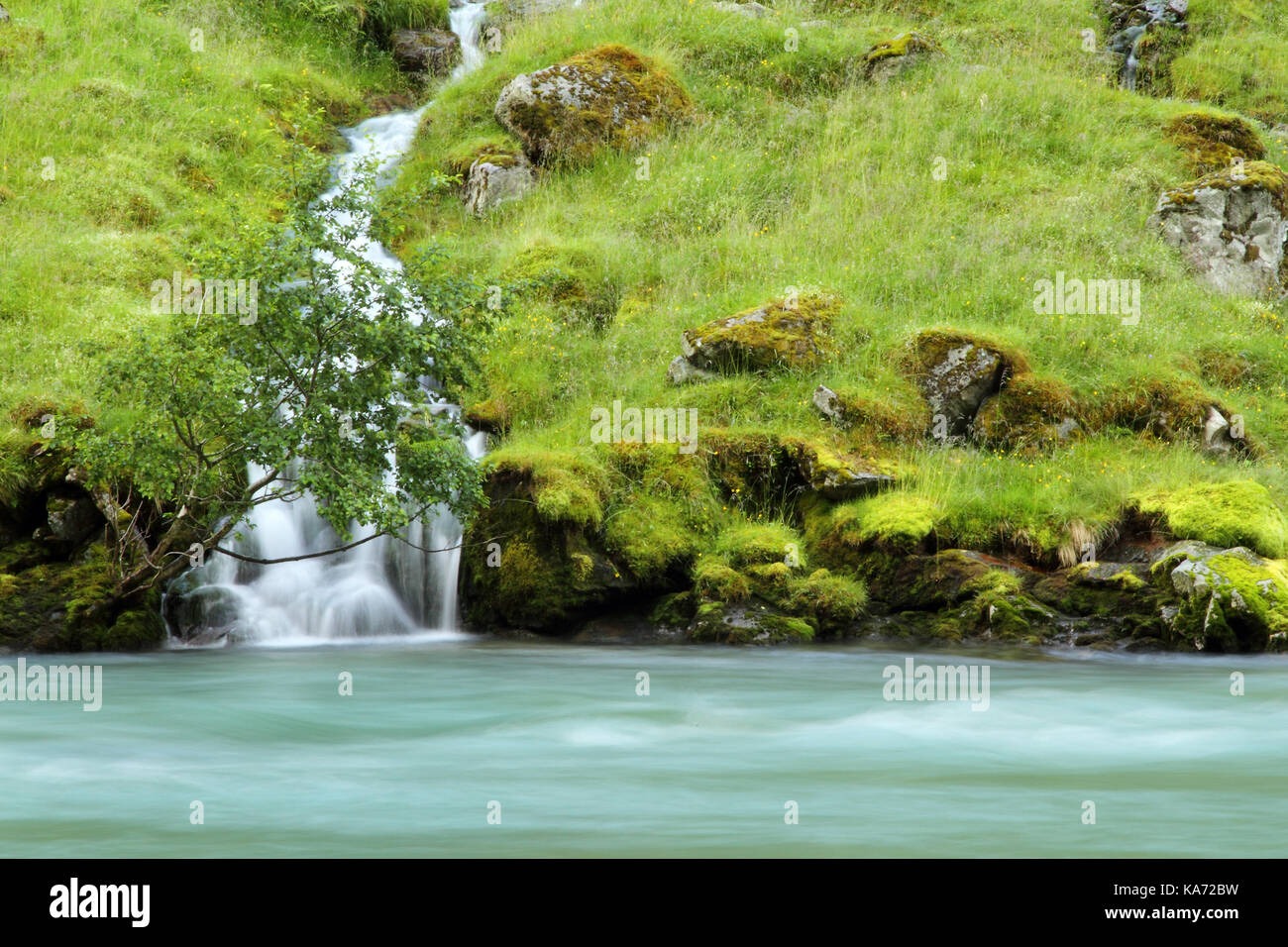 Waterfall to blue river in Norway Stock Photo - Alamy