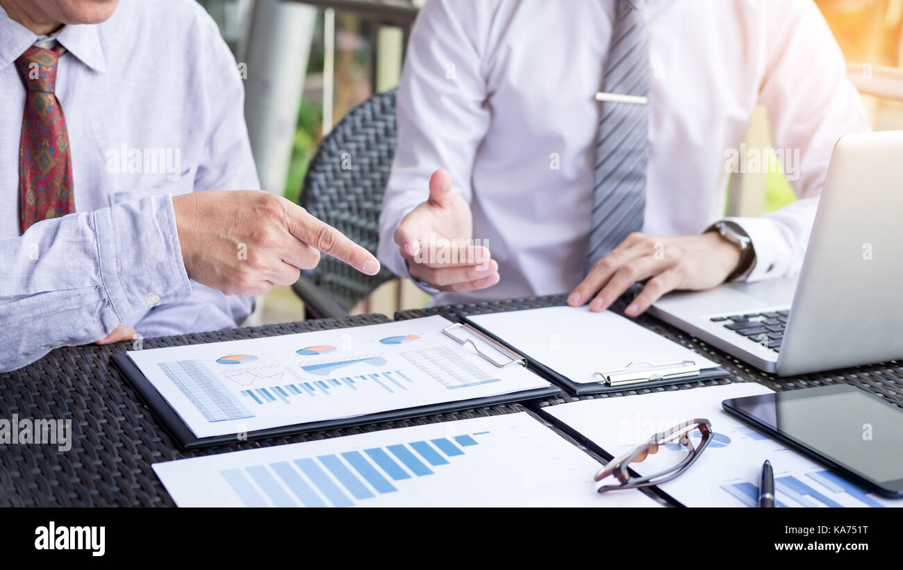 Business people discuss together about there work by graph document and ...