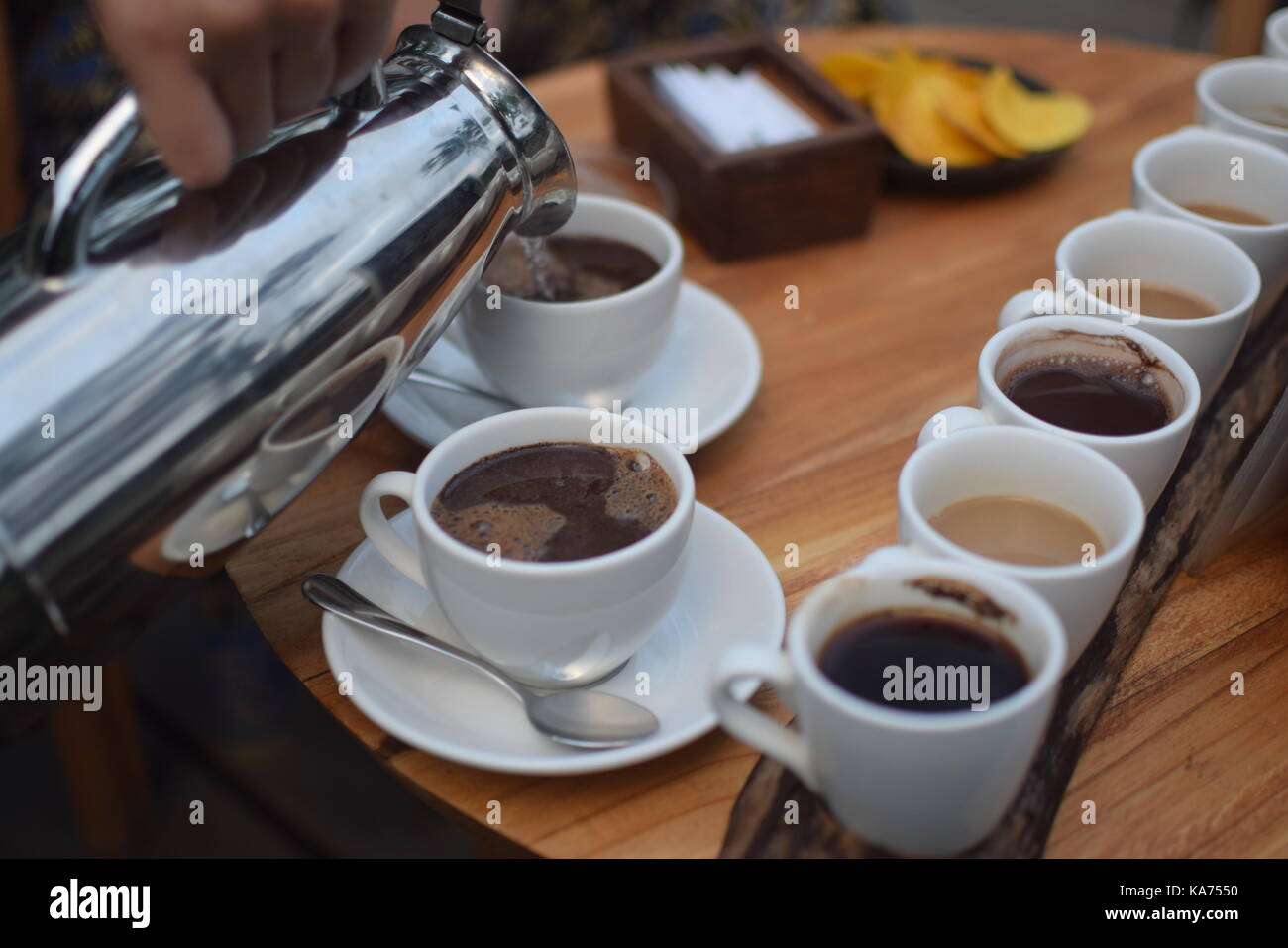 Eight kinds of coffee on a wooden tray, including Kopi Luwak, the ...