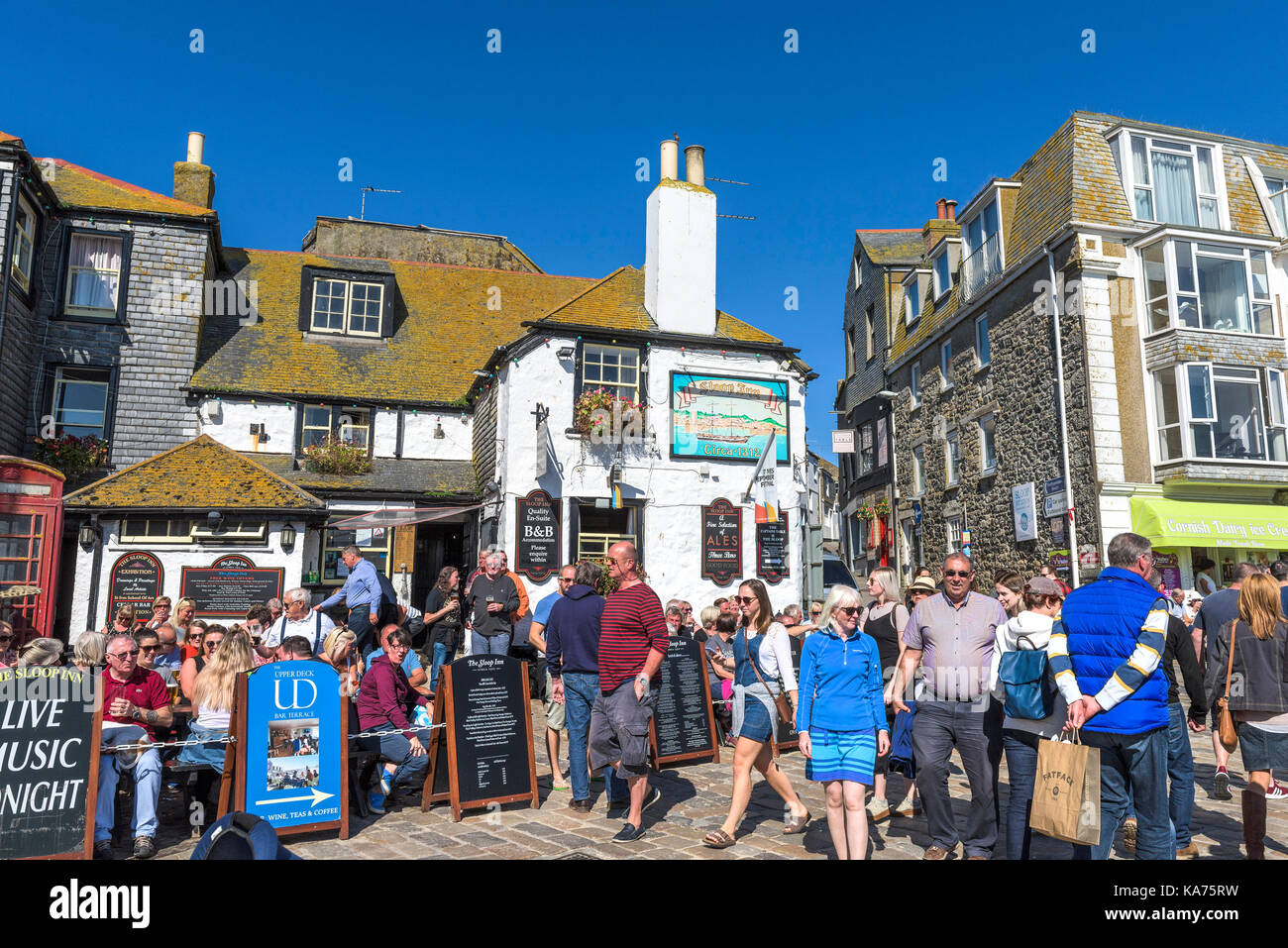 St Ives - holidaymakers relaxing at the historic Sloop Inn pub on the ...
