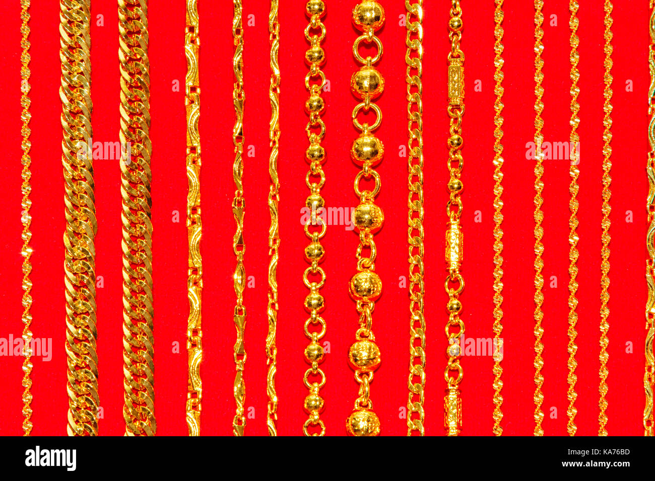 Gold neck lace ,Gold chains jewelry on red background Stock Photo - Alamy