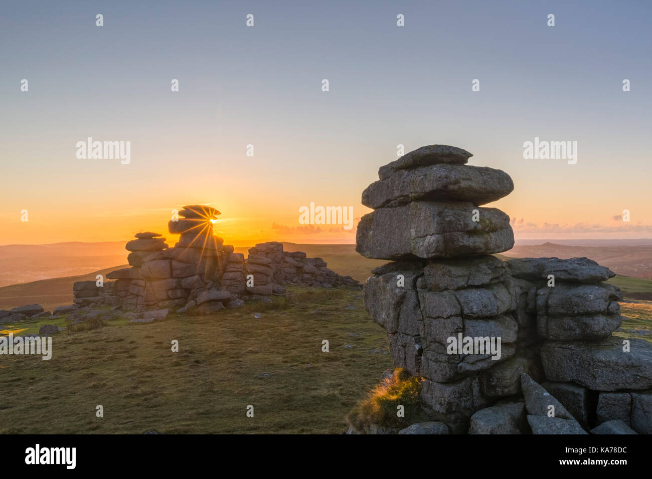 Sunset as the sun dips behind the granite outcrop with starburst effect ...