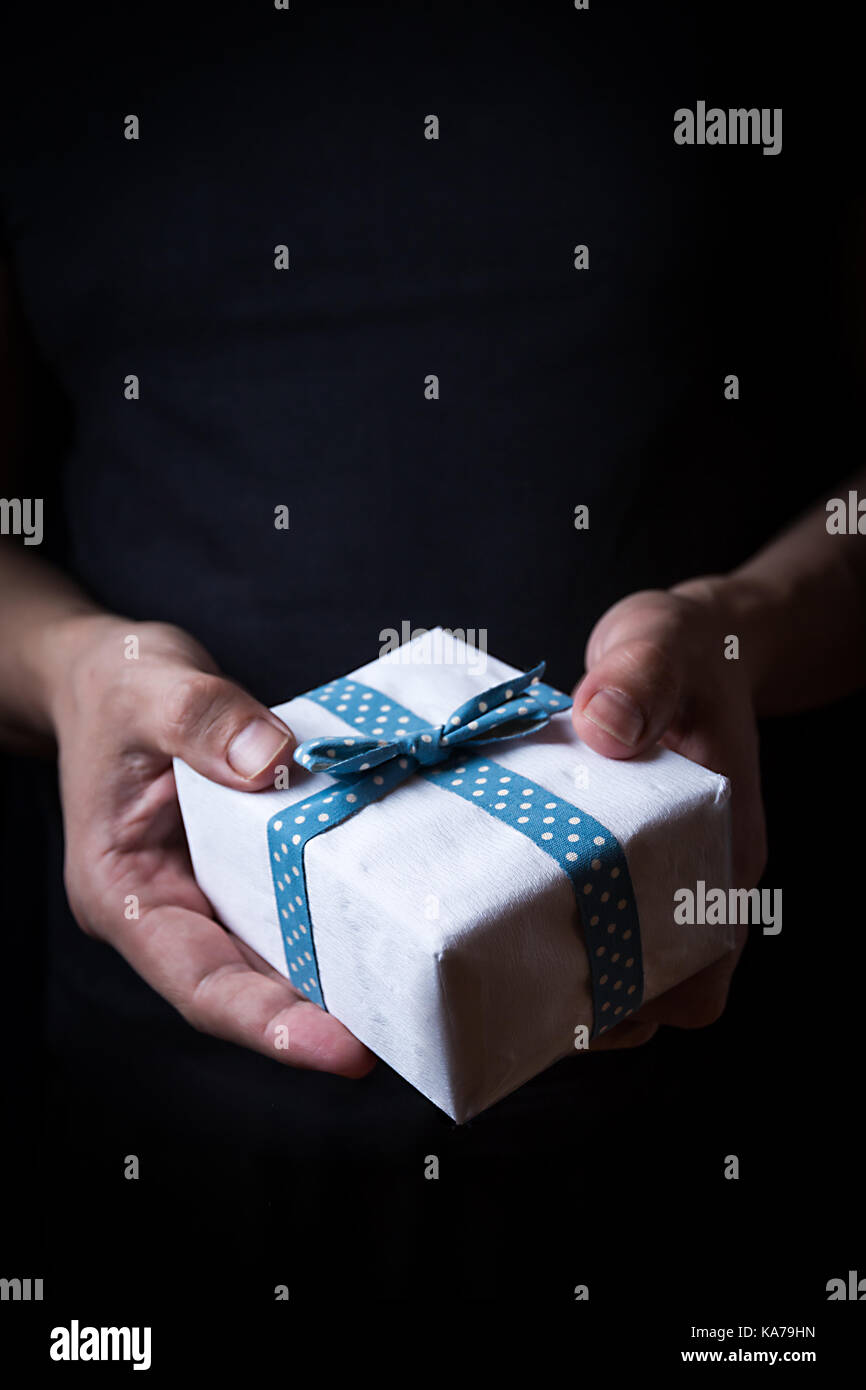 Hands holding a small gift Stock Photo - Alamy