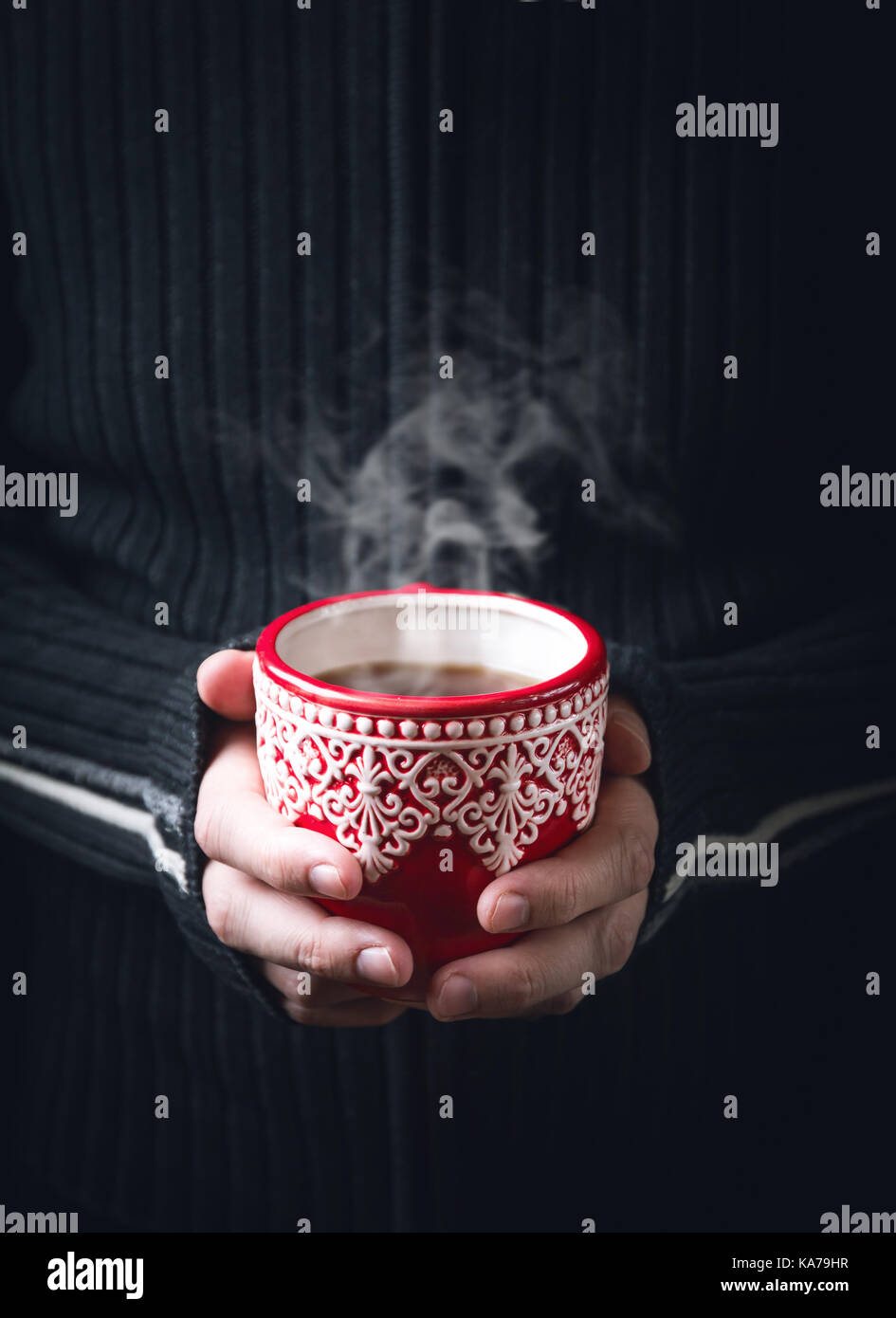Hands holding red mug Stock Photo - Alamy