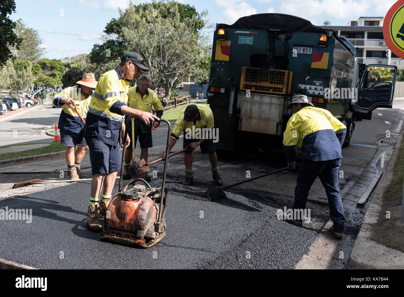 A road maintenance crew re-surfacing a road in Caloundra, Queensland ...