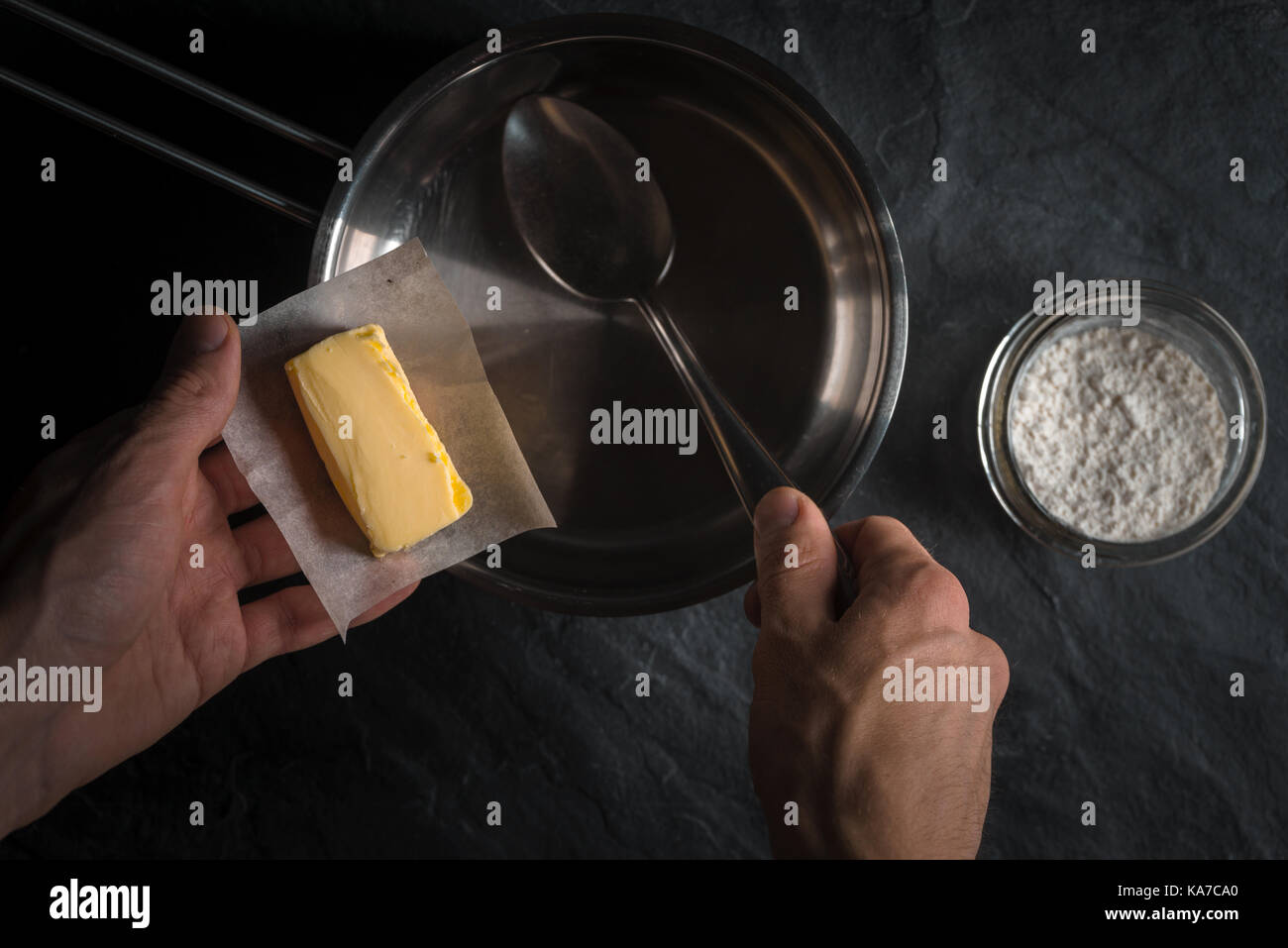 Hand put the butter in a bucket for making roux horizontal Stock Photo ...