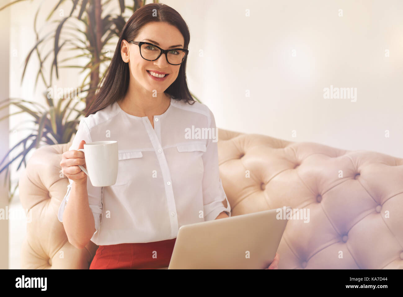 Beautiful woman expressing positivity at work Stock Photo - Alamy