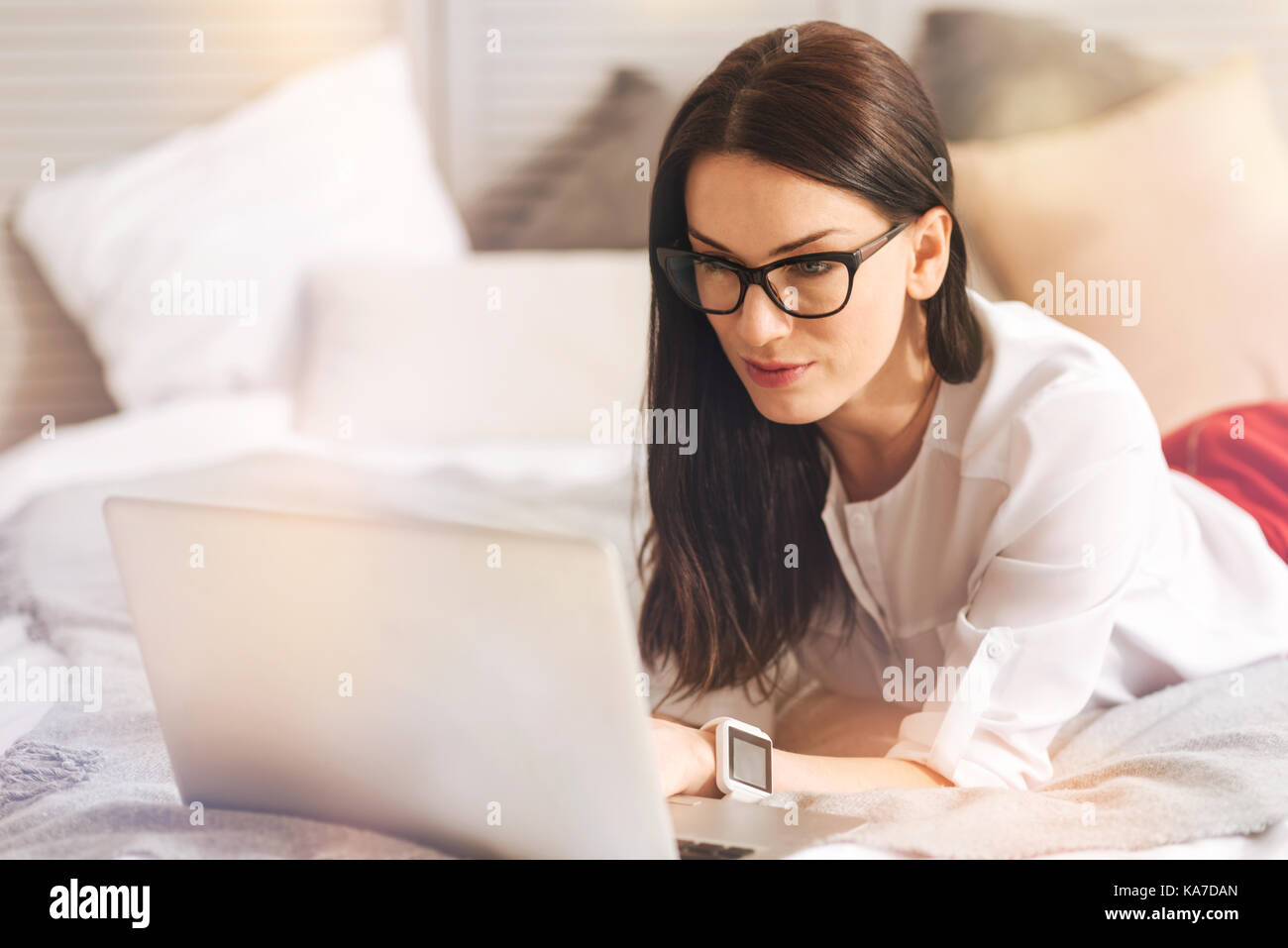 Positive delighted young woman looking at her computer Stock Photo - Alamy