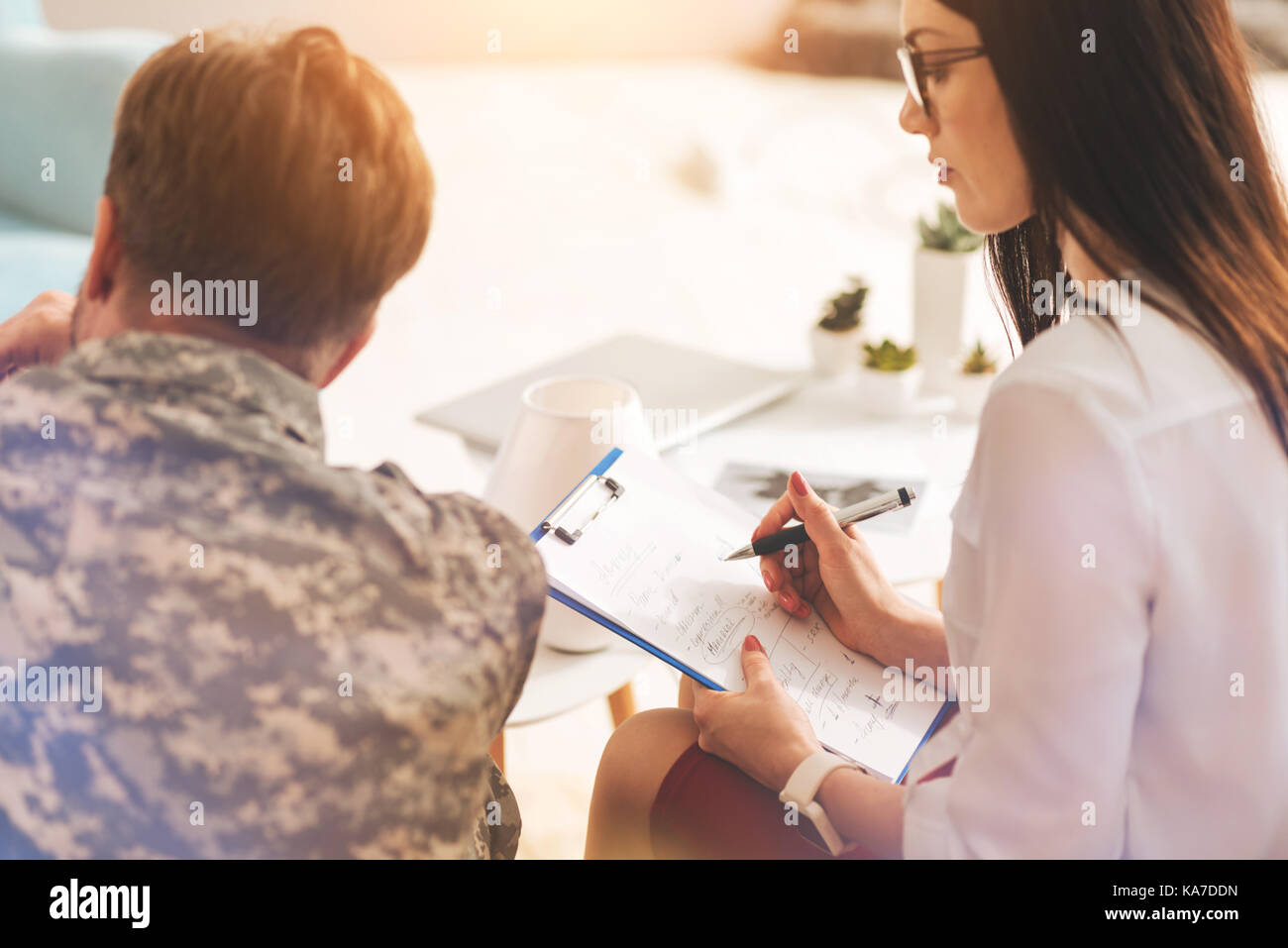 Attentive brunette female thinking how to help her client Stock Photo ...