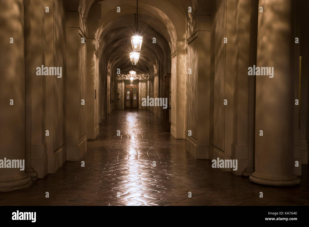 Ancient architectural hallway at night lighted by artificial light ...