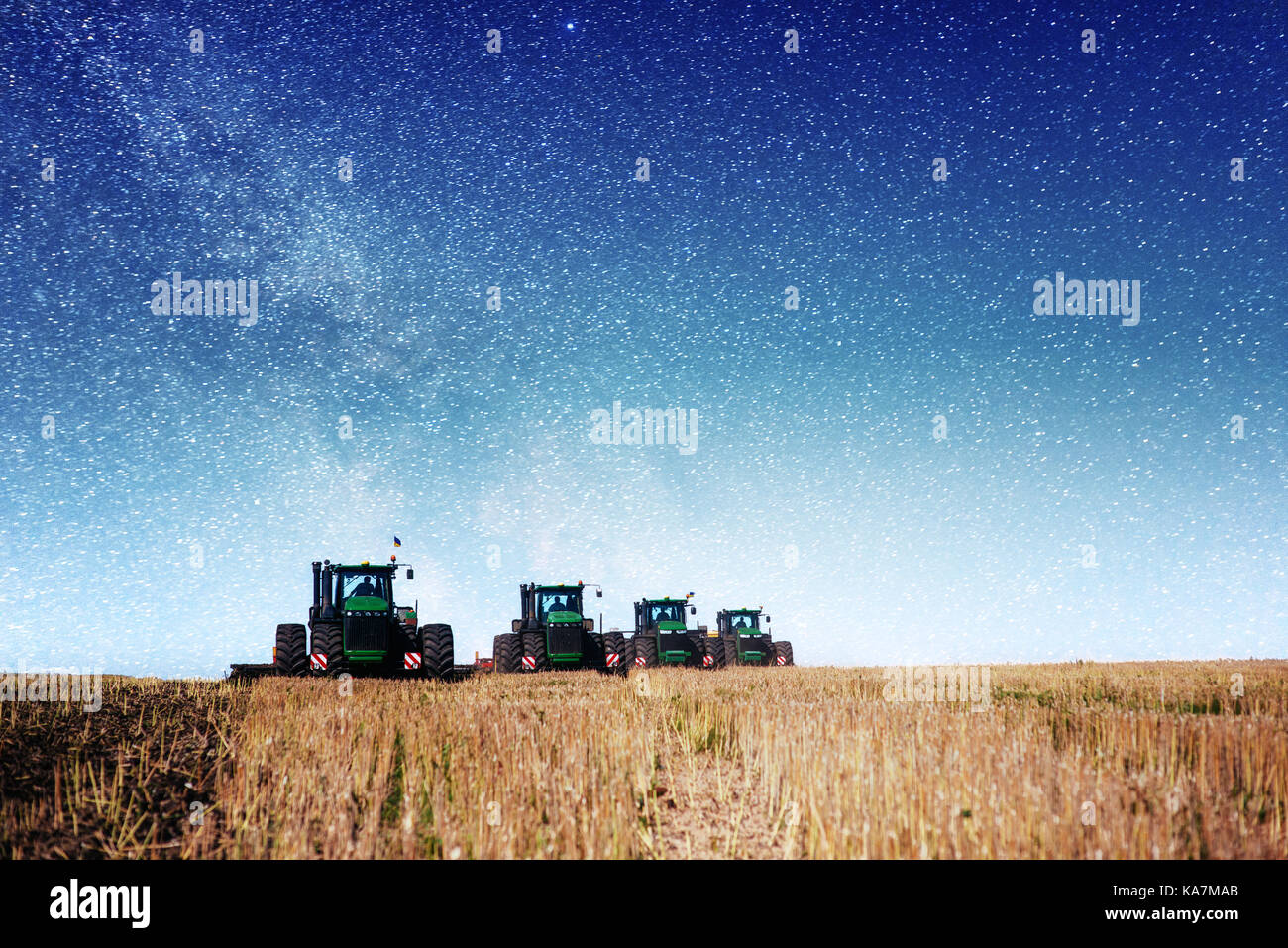 Tractor plowing farm field in preparation for spring planting ...