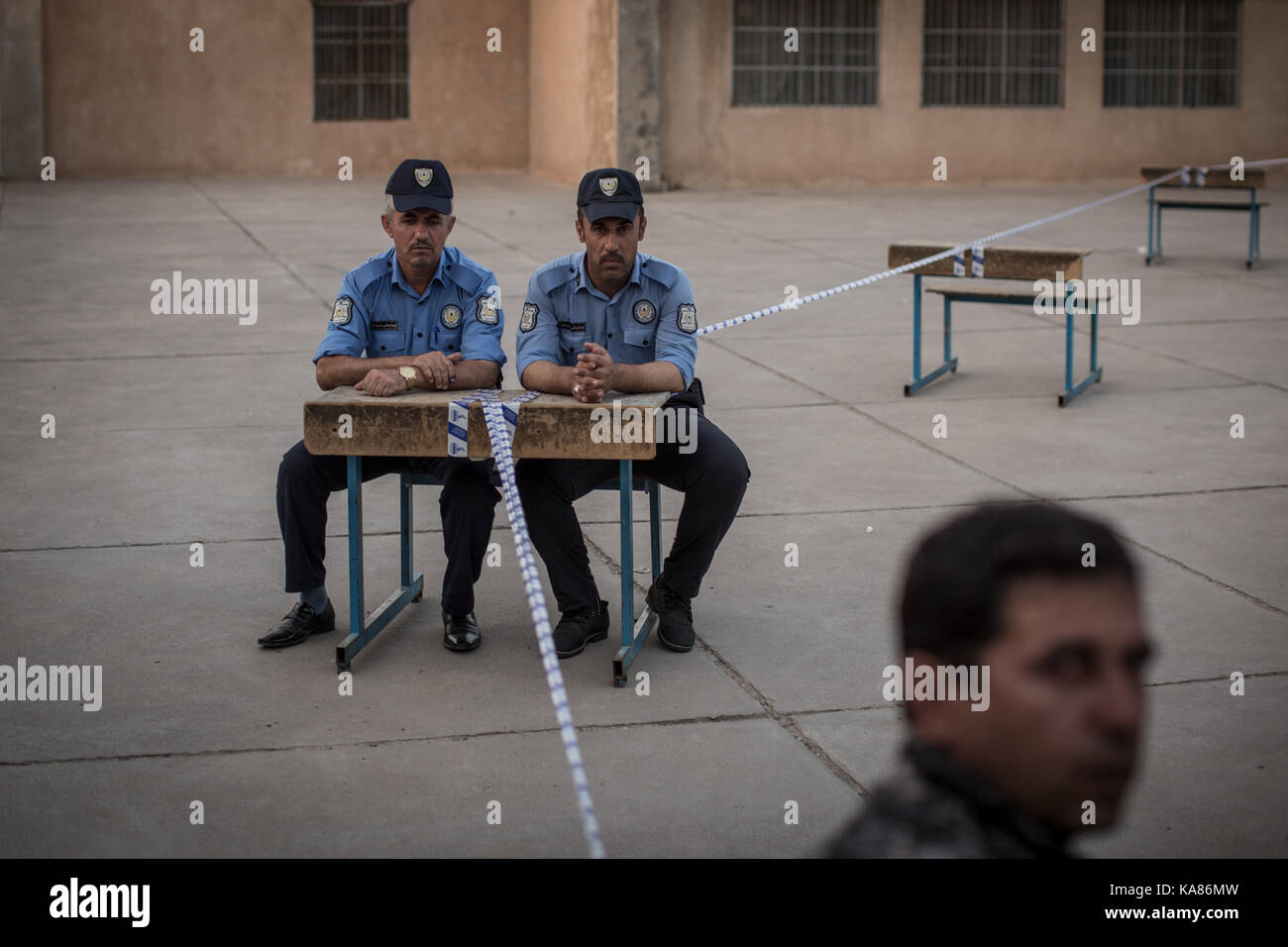 Erbil, Iraq. 25th Sep, 2017. Kurdish police men sit on school benches ...