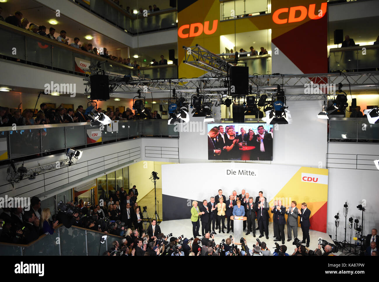 German Chancellor Angela Merkel (M) is standing on stage after learning ...