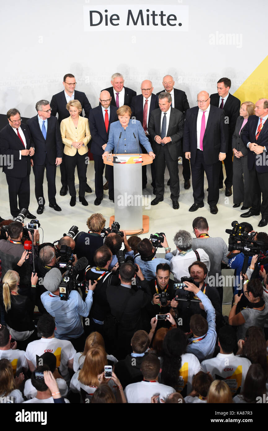 German Chancellor Angela Merkel (M) is standing on stage after learning ...
