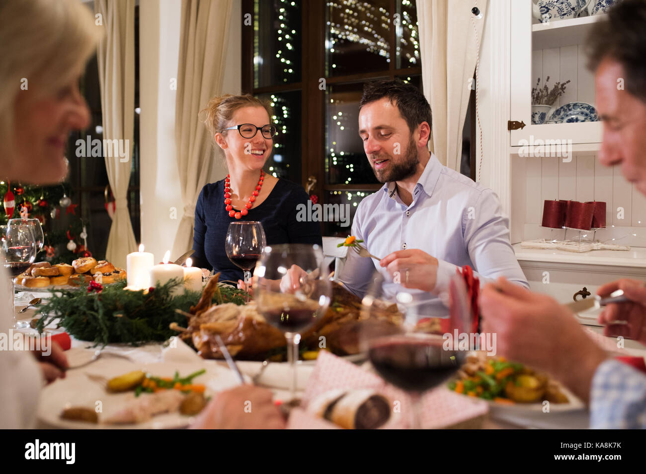 Beautiful couple celebrating Christmas together with the family Stock ...