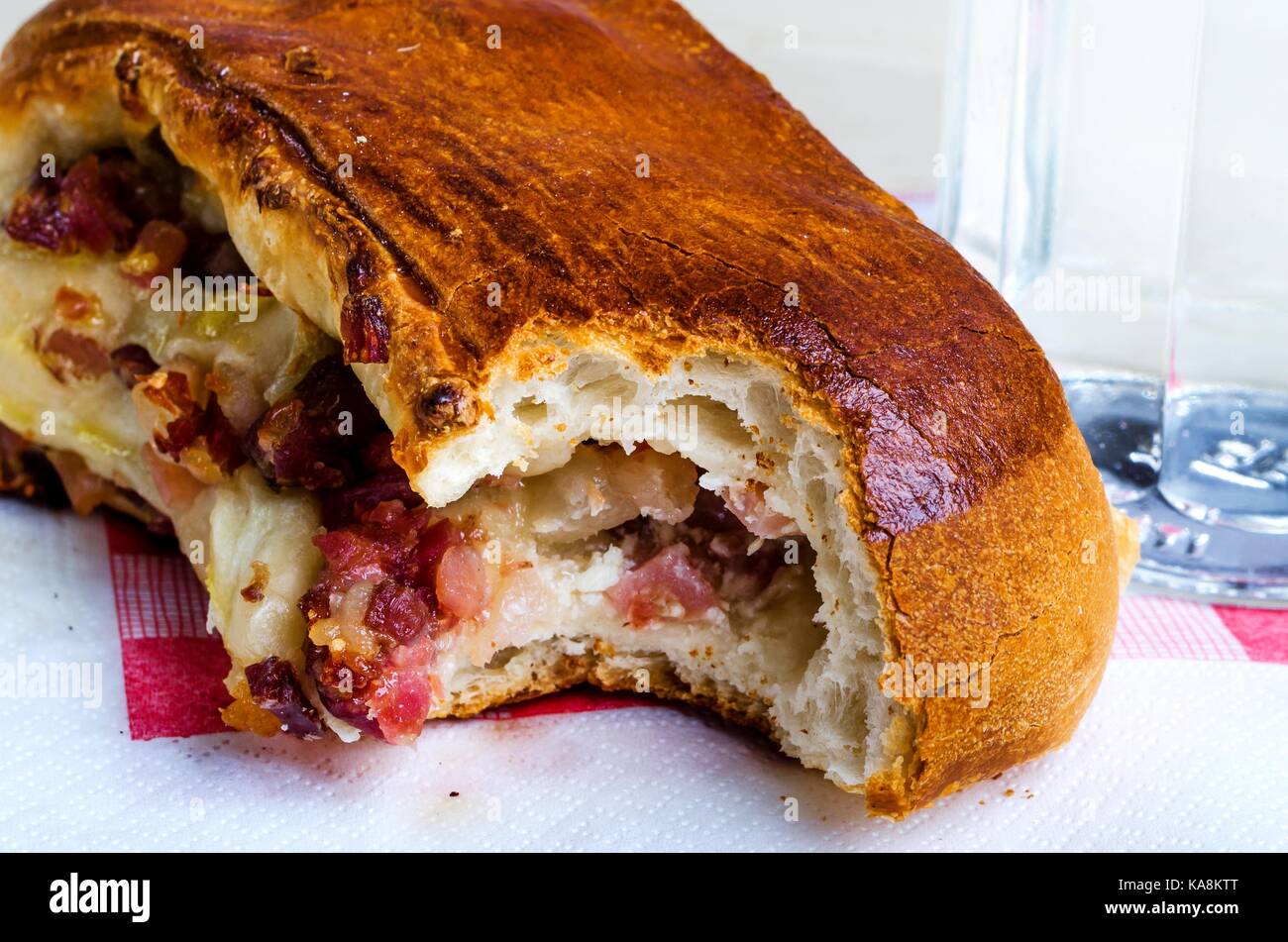 Bitten neapolitan sandwich with bacon pieces cheese Stock Photo - Alamy