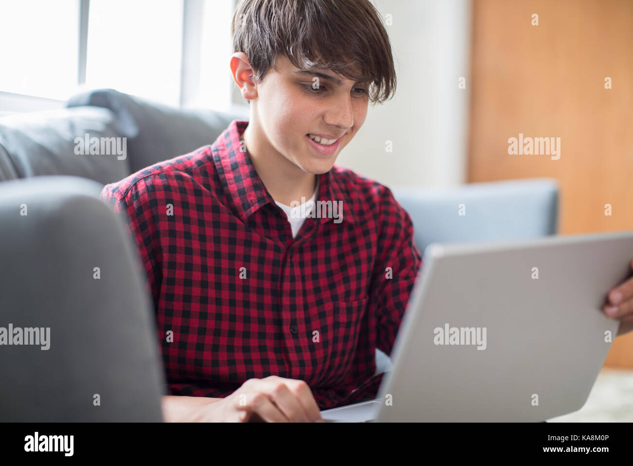 Teenage Boy Working On Laptop At Home Stock Photo - Alamy