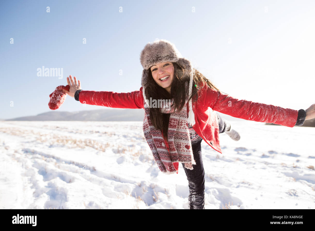 Beautiful young woman, having fun in the snow Stock Photo - Alamy