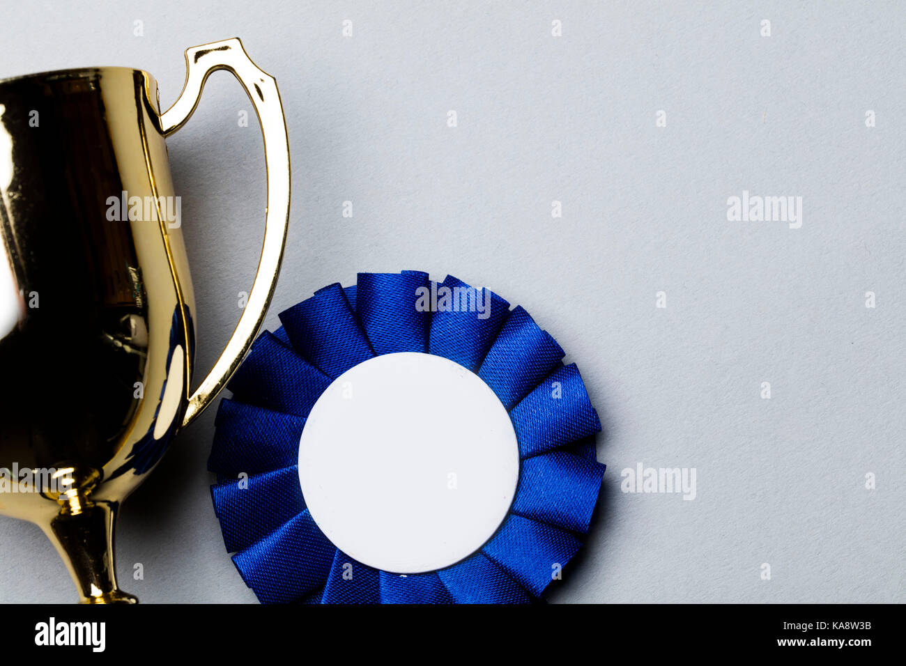 First place trophy and award rosette. Success achievement concept Stock ...