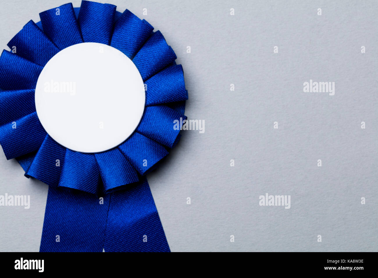 First place award rosette with blank white centre. Success achievement ...