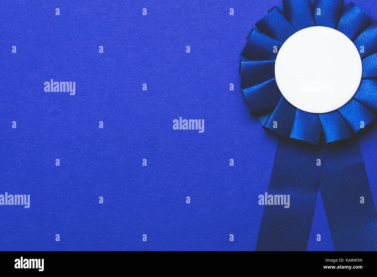 First place award rosette with blank white centre. Success achievement ...