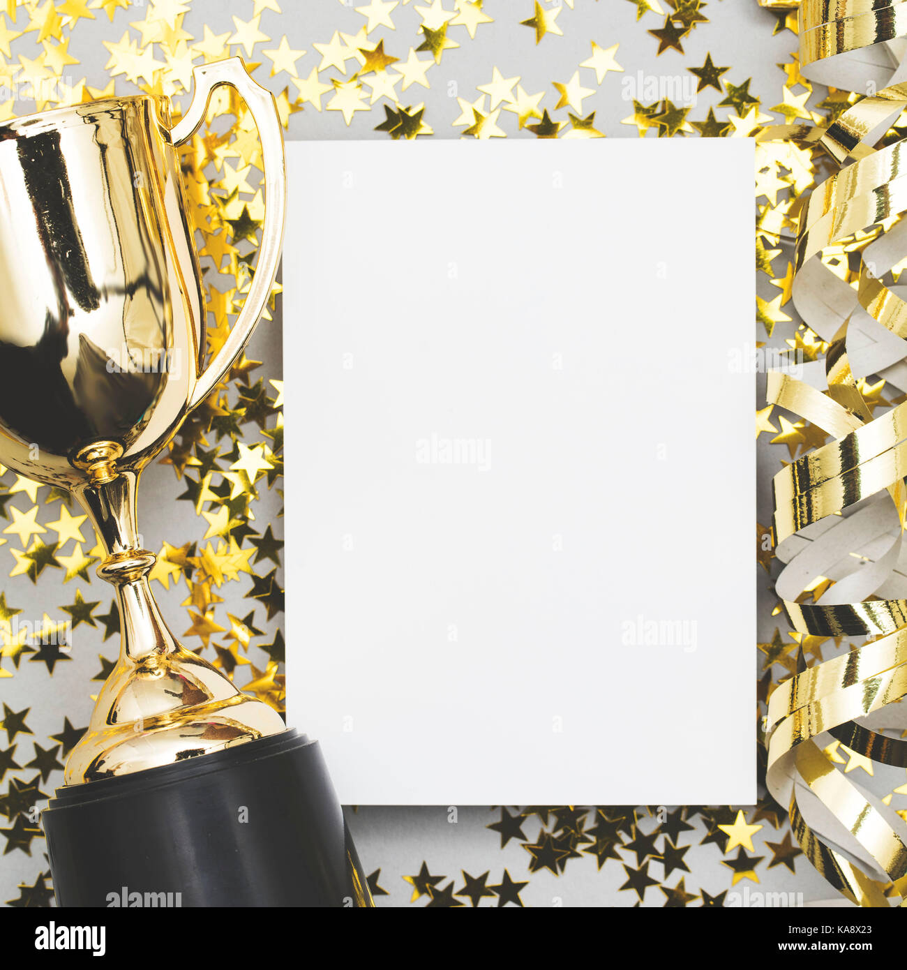 Gold winners trophy with a blank poster label and golden shiny stars ...