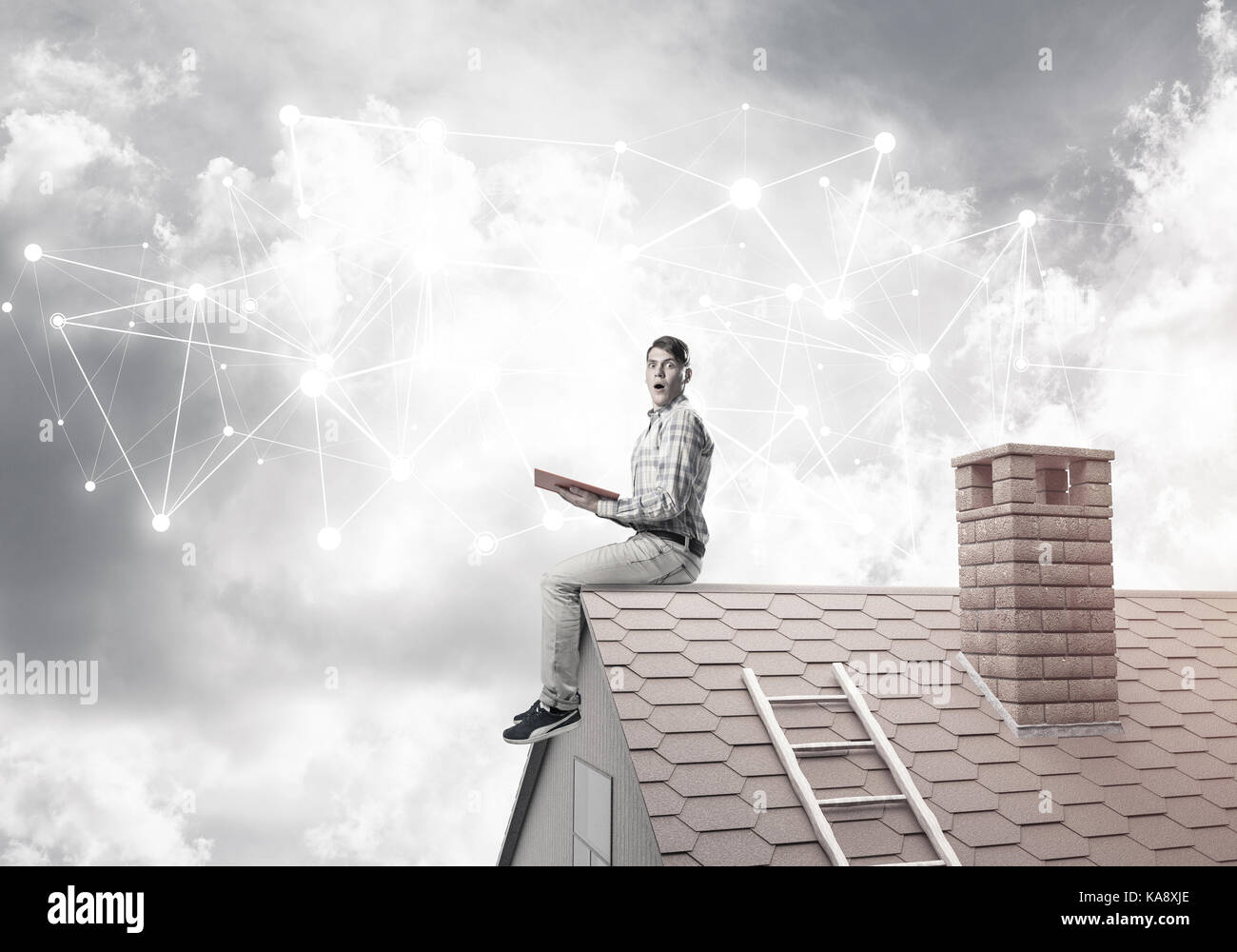 Man on brick roof reading book and concept of social connection Stock ...