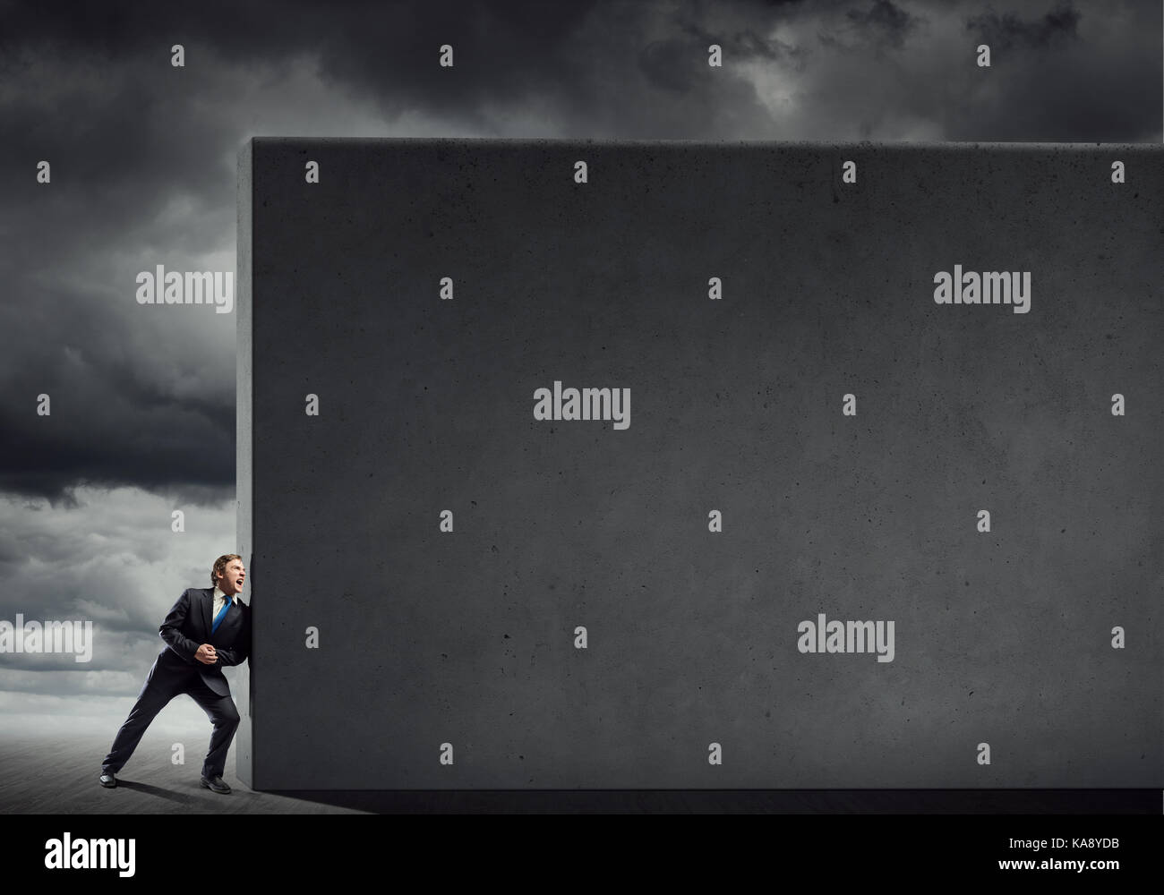 Businessman push wall Stock Photo - Alamy