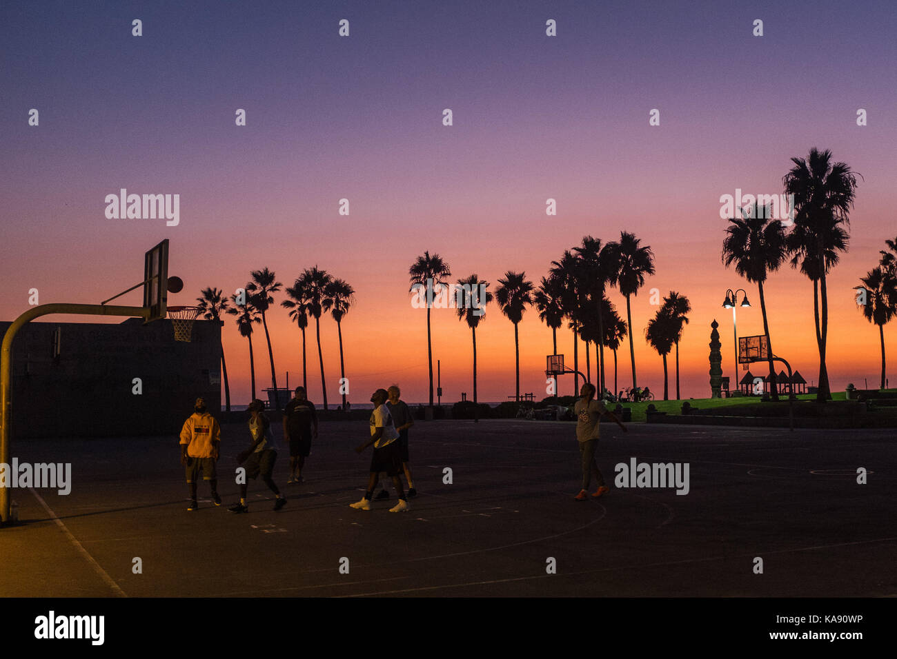 People play basketball during sunset on Venice Beach, Los Angeles ...
