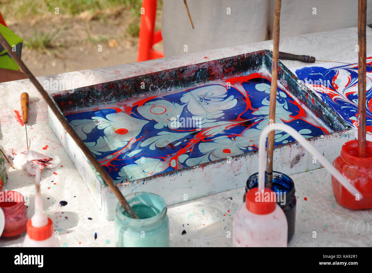Oil-based inks in a tank of water being prepared for marbling Stock ...