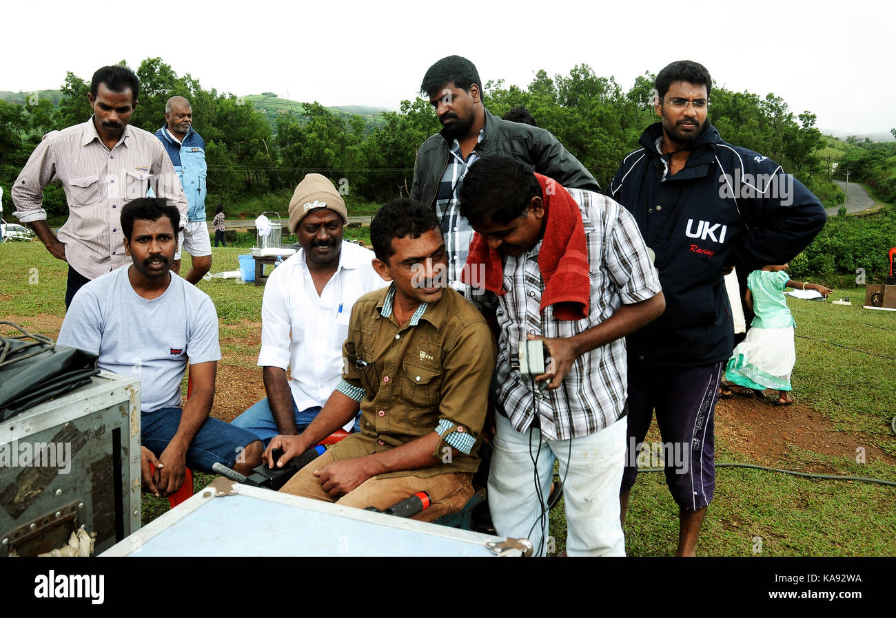 Film Crew On Location Morning Shoot watching a performance reply at ...