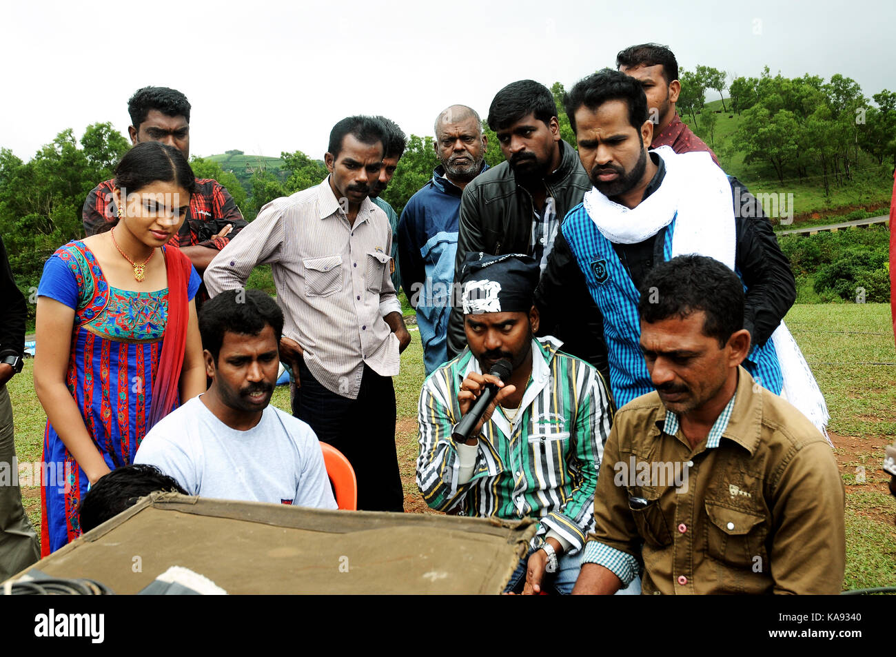 Film Crew On Location Morning Shoot watching a performance reply at ...