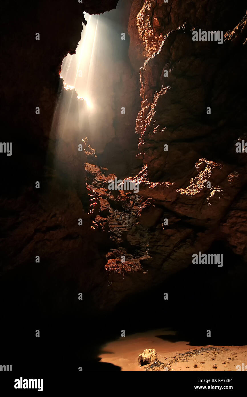 Mysterious light in a dark cave Stock Photo - Alamy