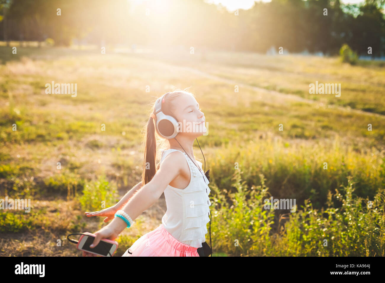 Pretty girl listening music and dancing Stock Photo - Alamy