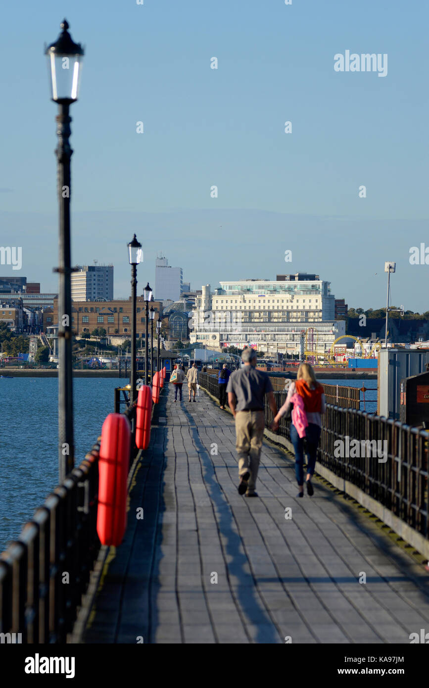 Southend pier walkway with walkers. Palace Hotel at the far land end ...