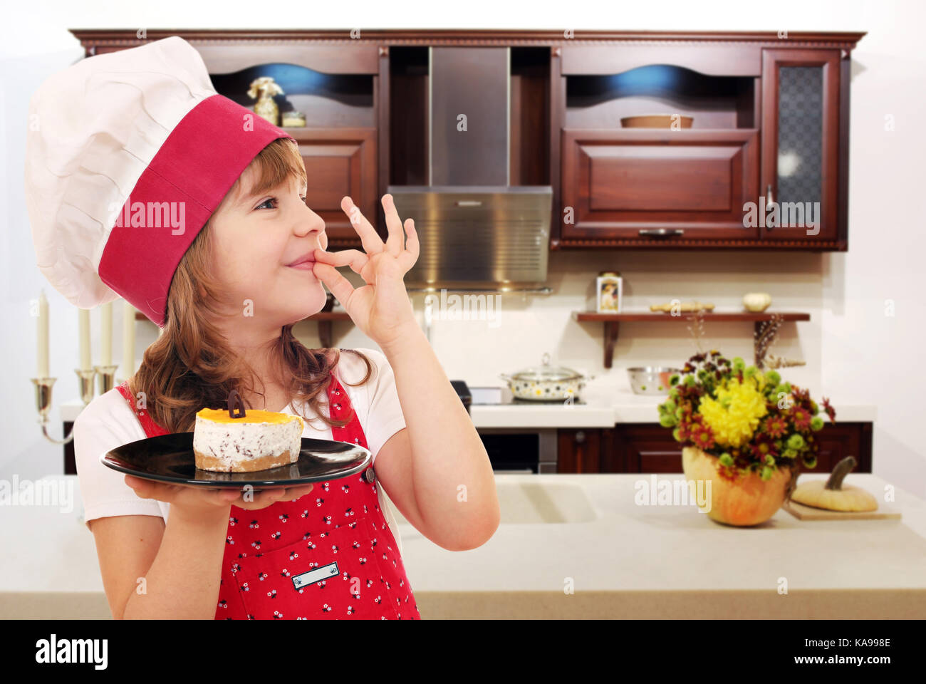 happy little girl cook with cake and ok hand sign in kitchen Stock ...