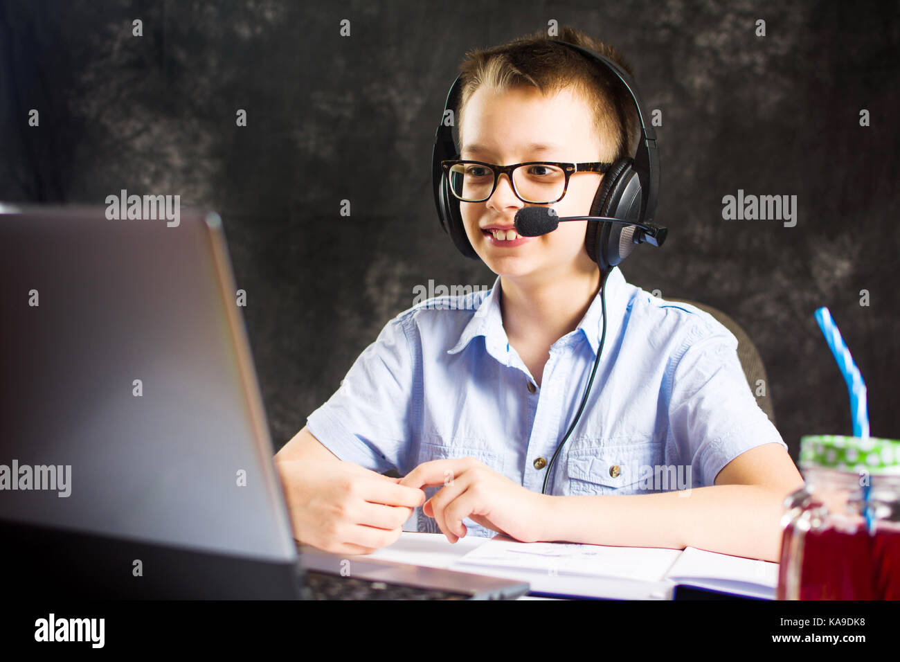 Teenage boy having a video call with headset Stock Photo - Alamy